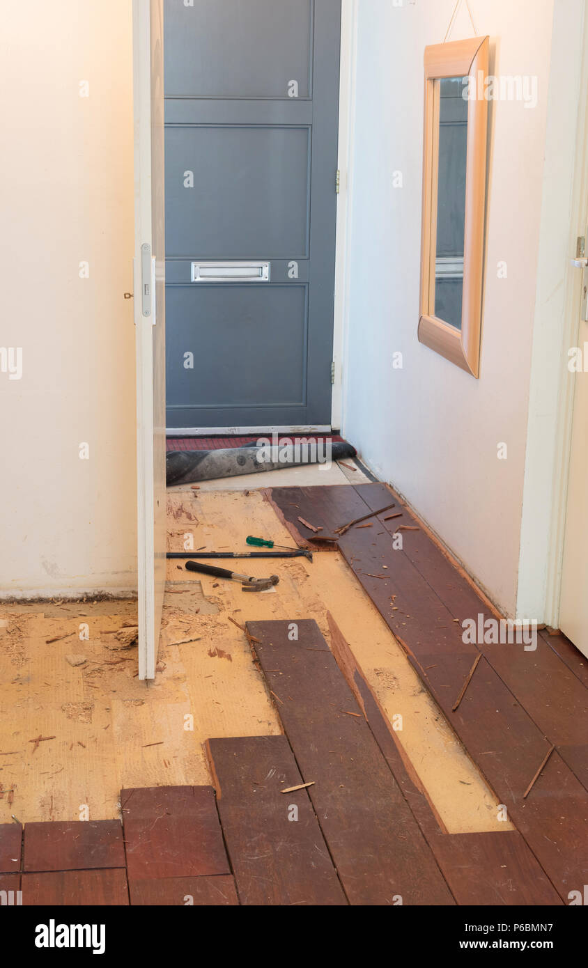 Breaking up a solid wooden floor in a house Stock Photo - Alamy