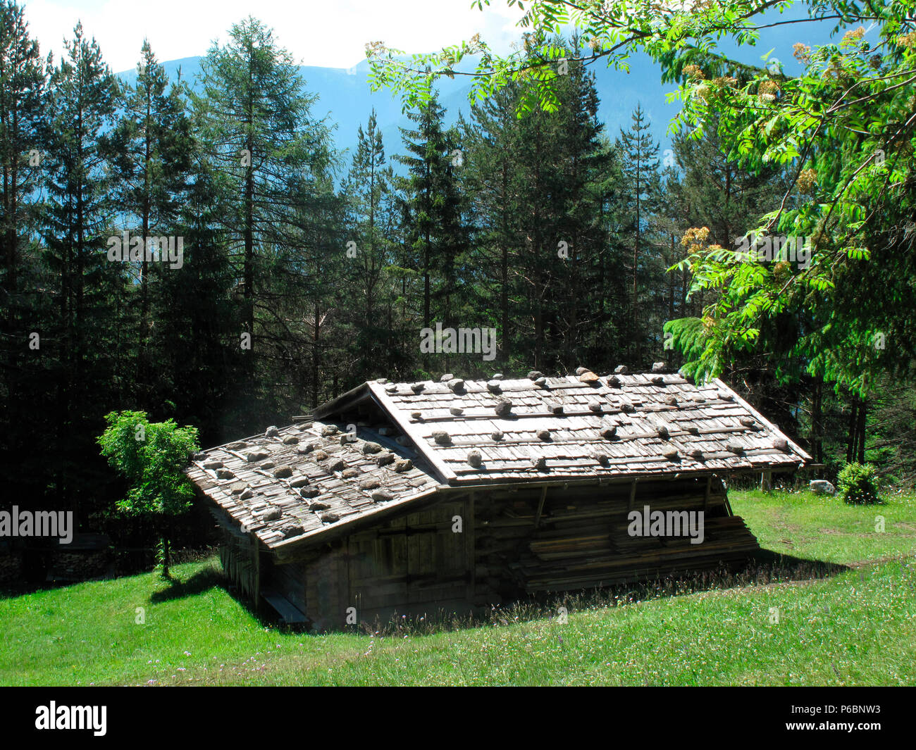 Austria,Tirol,a small wooden hut is covered by big stones to maintain ...