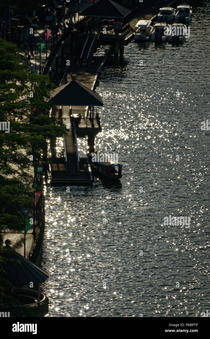 Sunshine reflecting on the Sarawak River makes the Kuching Riverside ...