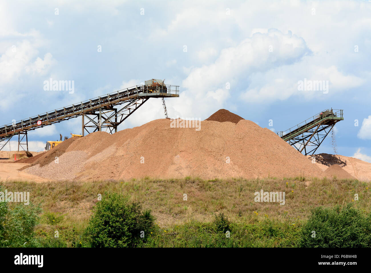 Conveyor belts depositing used material into huge piles at quarry Stock ...