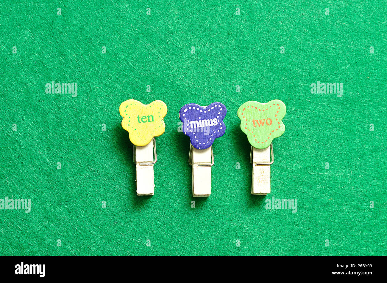 Ten minus two on a green background Stock Photo - Alamy