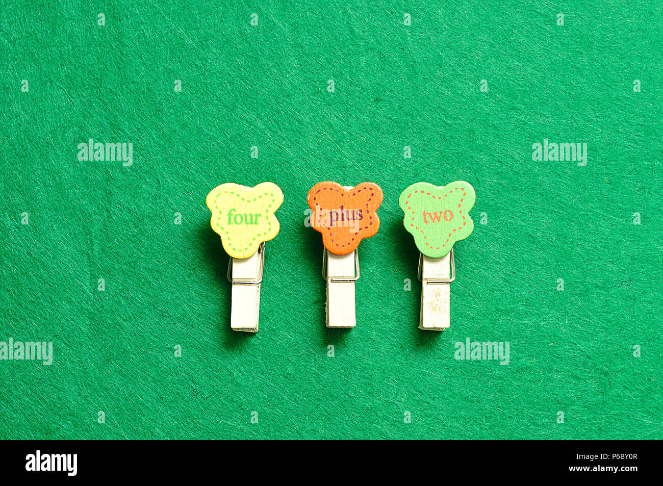 Four plus two on a green background Stock Photo - Alamy