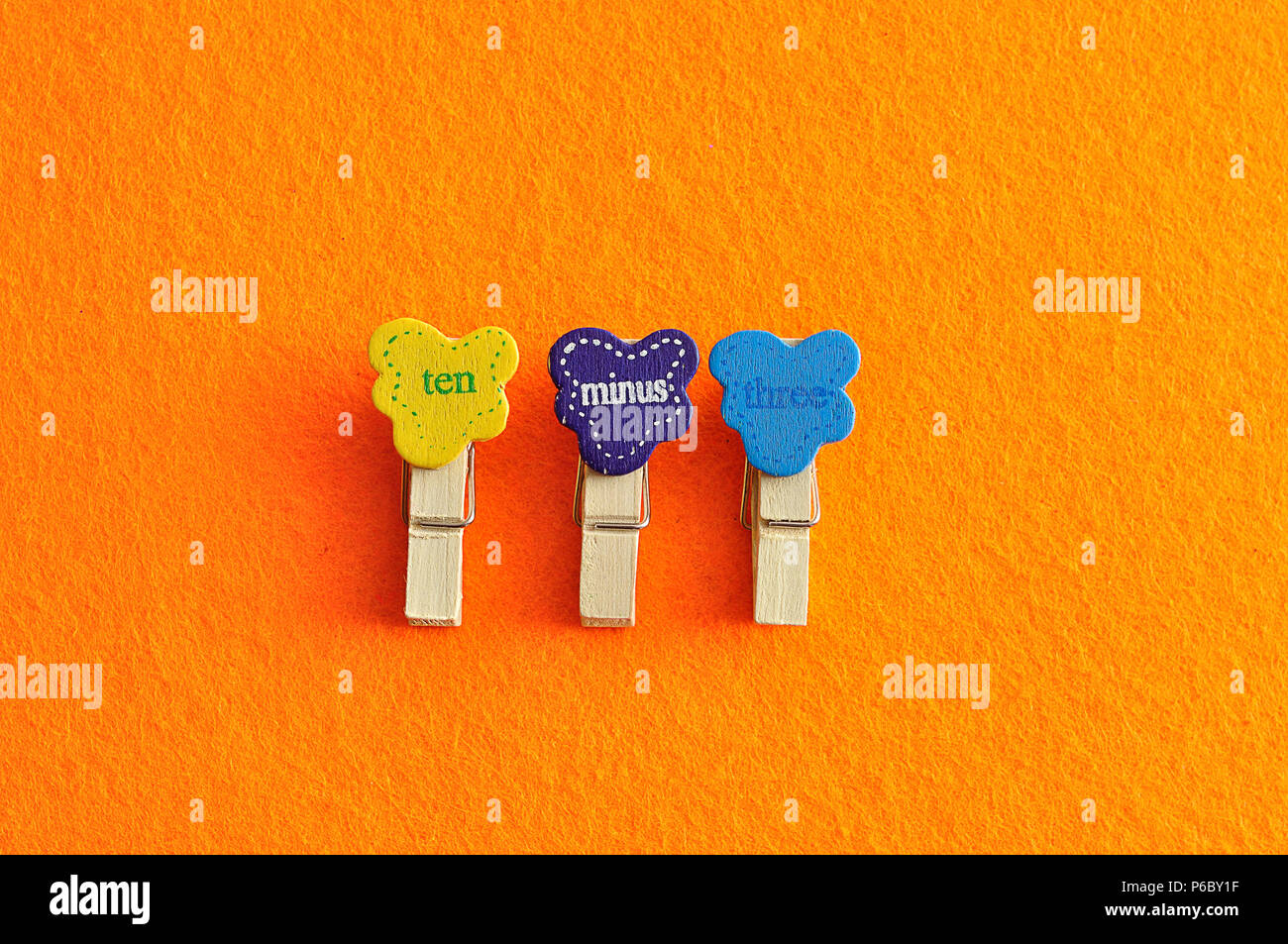 Ten minus three on an orange background Stock Photo - Alamy