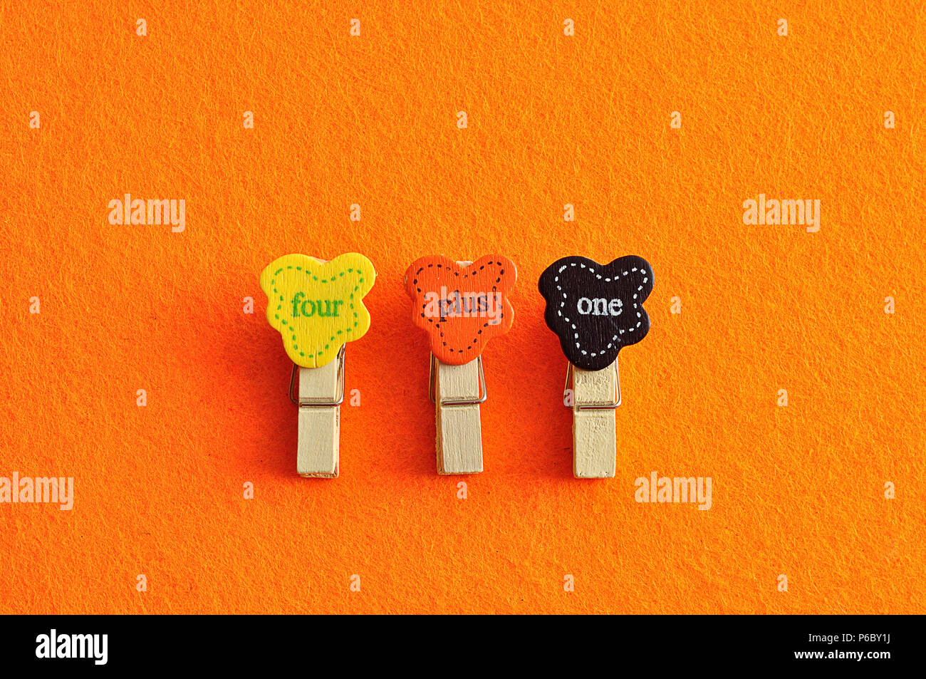 Four plus one on an orange background Stock Photo - Alamy