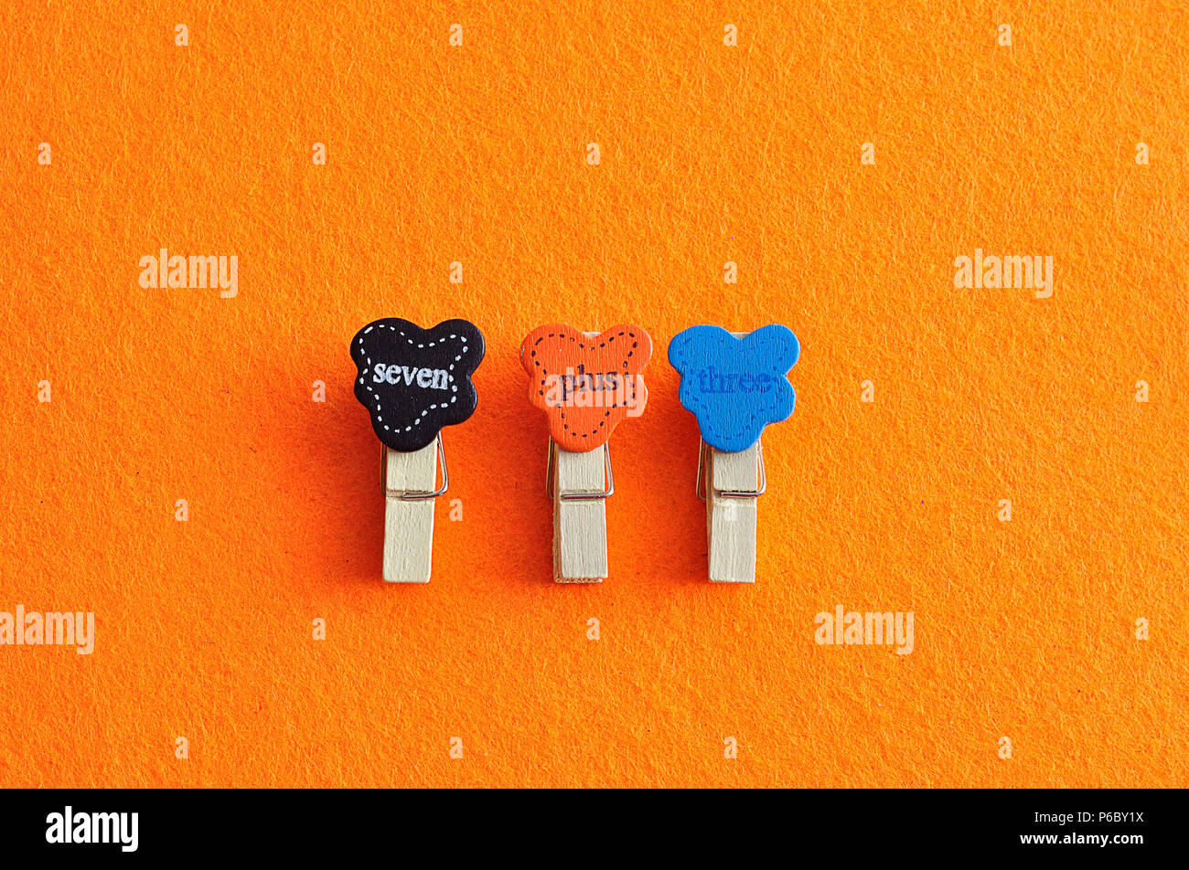 Seven plus three on an orange background Stock Photo - Alamy