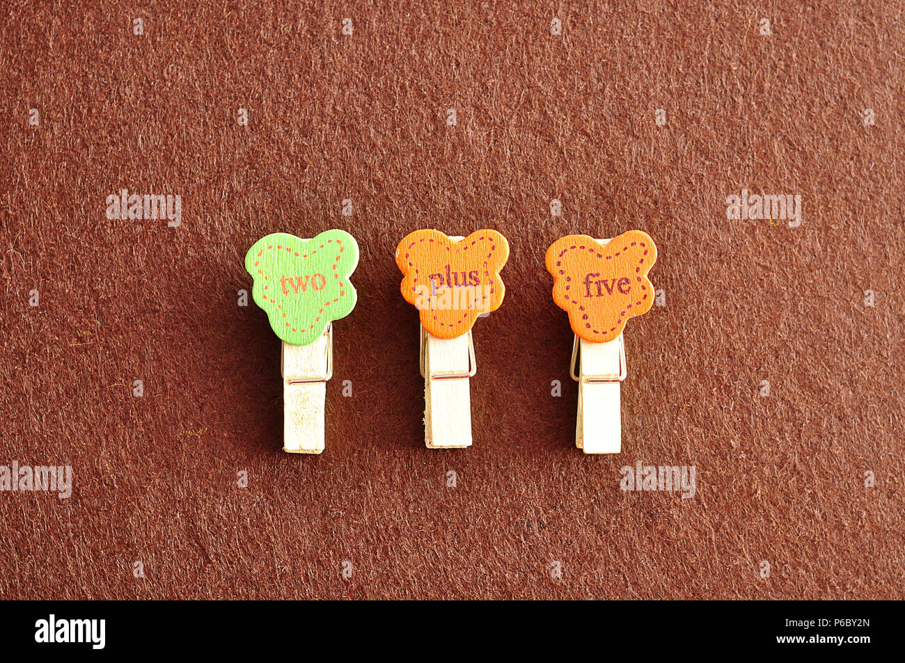 Two plus five on a brown background Stock Photo - Alamy
