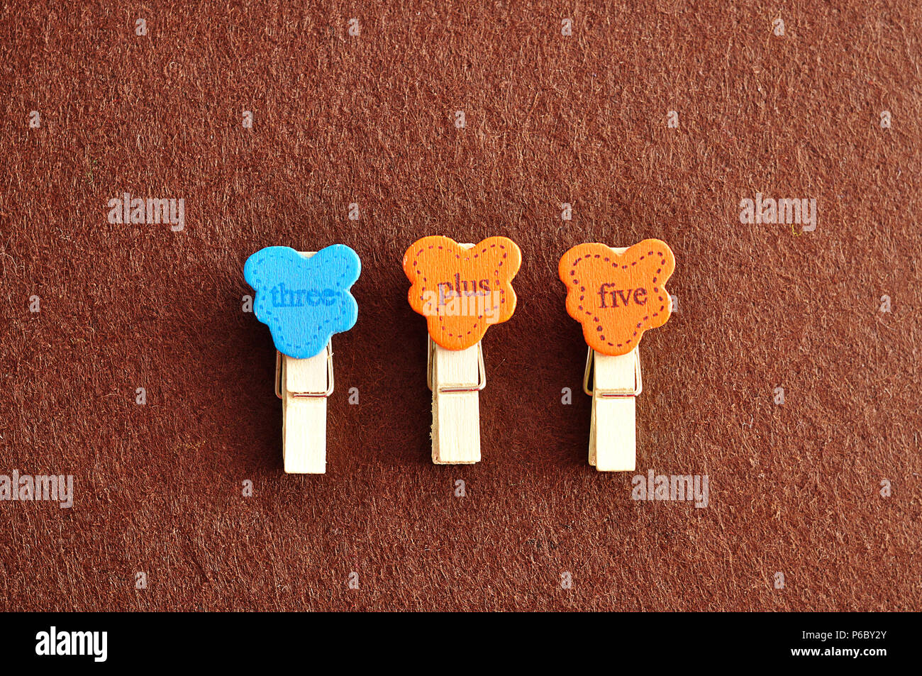 Three plus five on a brown background Stock Photo - Alamy