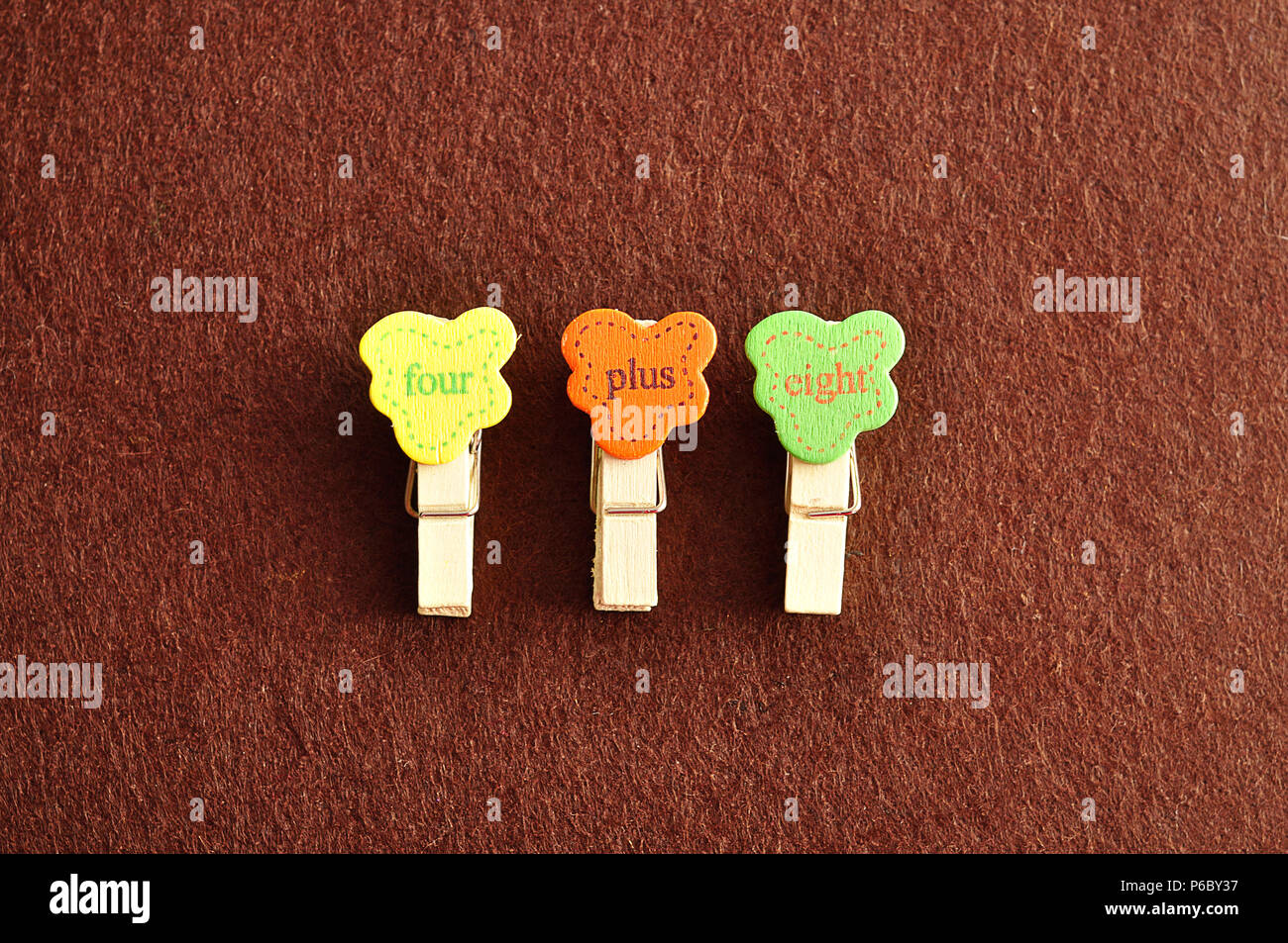 Four plus eight on a brown background Stock Photo - Alamy