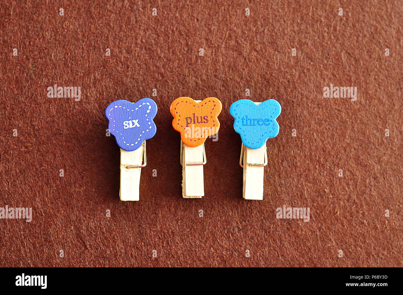 Six plus three on a brown background Stock Photo - Alamy
