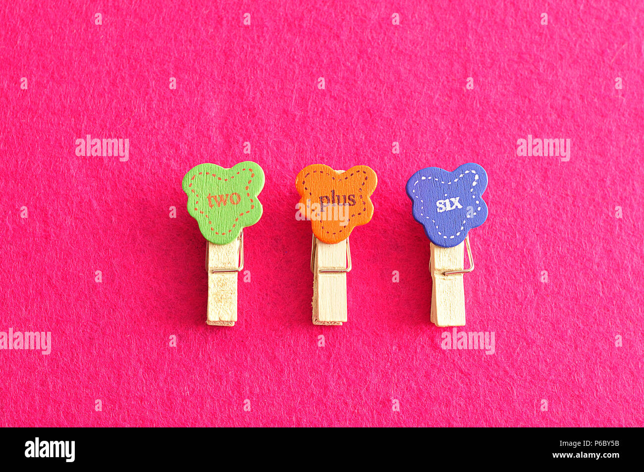 Two plus six on a pink background Stock Photo - Alamy