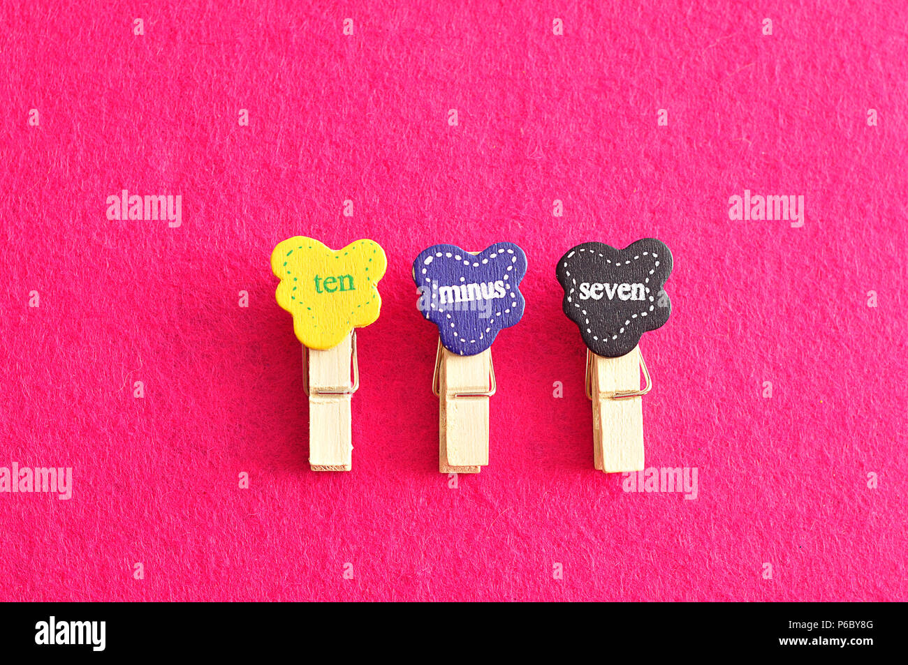 Ten minus seven on a pink background Stock Photo - Alamy
