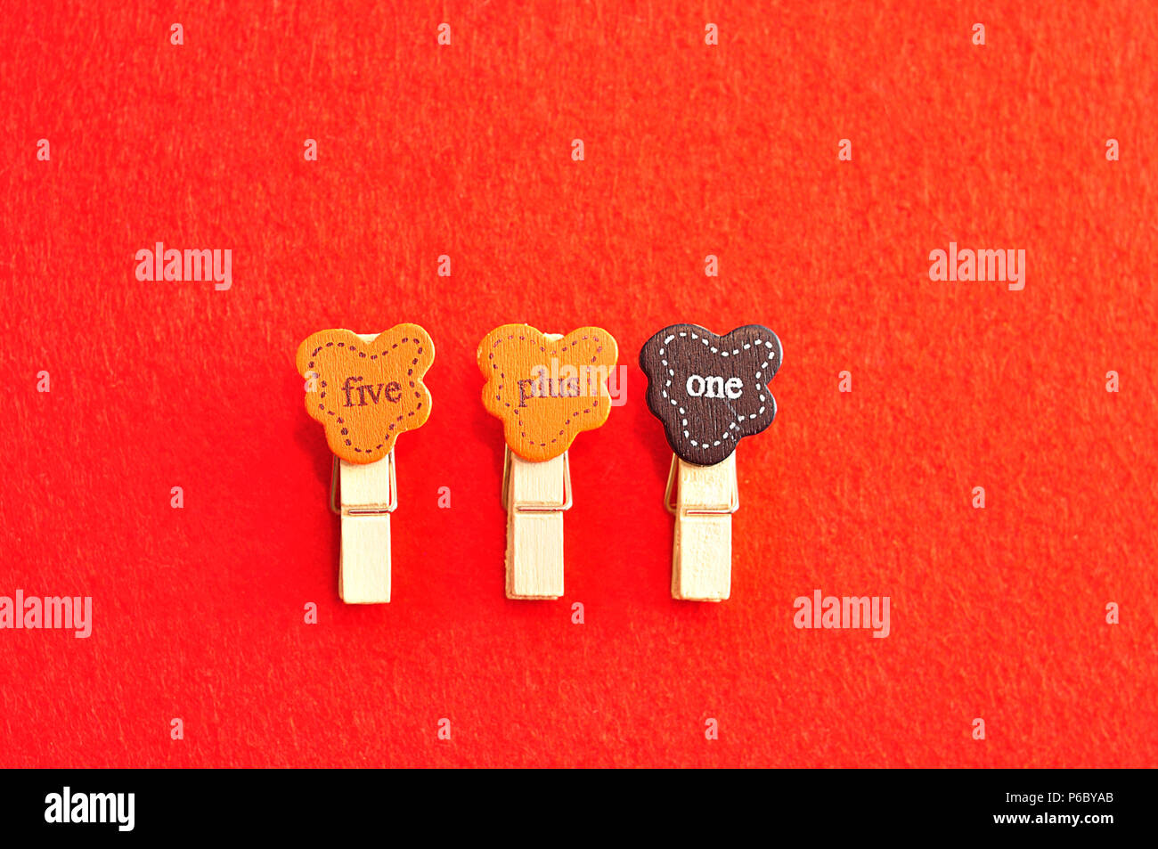 Five plus one on a red background Stock Photo - Alamy