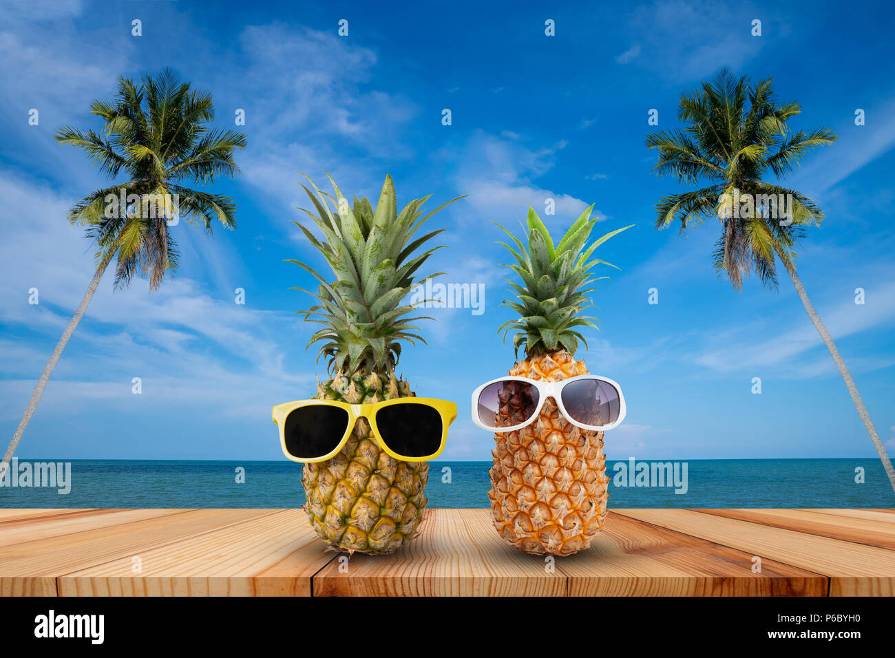 Pineapple on wooden table in a tropical landscape, Fashion hipster ...