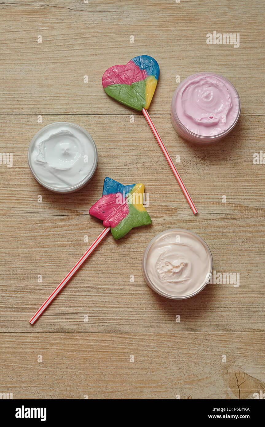 A collection of different jars of body lotion displayed with a star ...