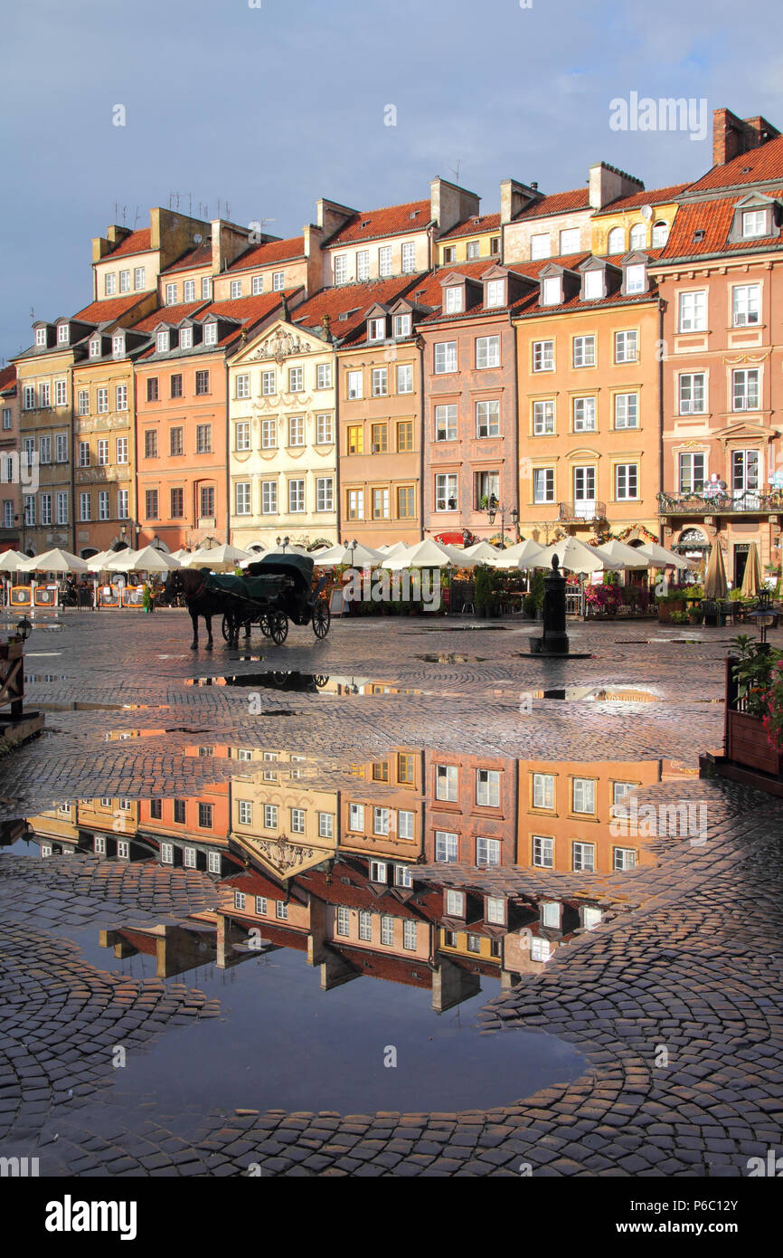 Warsaw, Poland. Old Town rain puddle reflection - tenements at the main ...