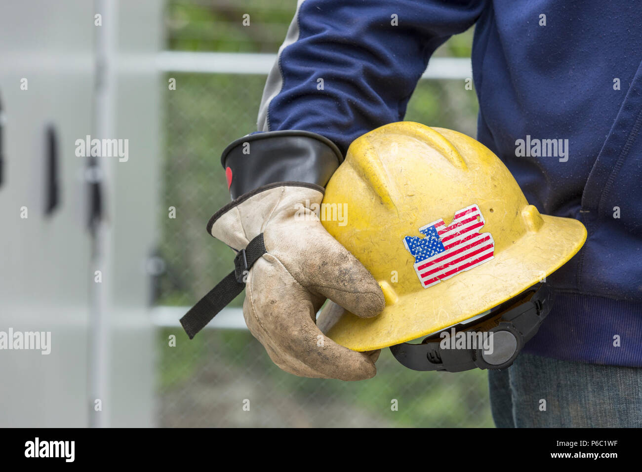 Engineer carrying hard hat with rubber protective gloves Stock Photo ...