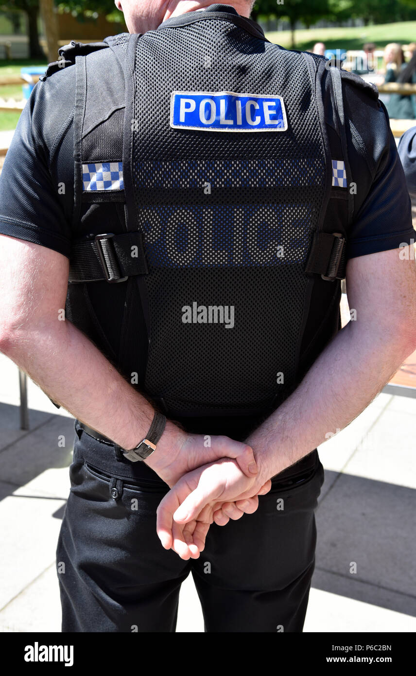 Uniformed police officer on duty at a local school, Alton, Hampshire ...