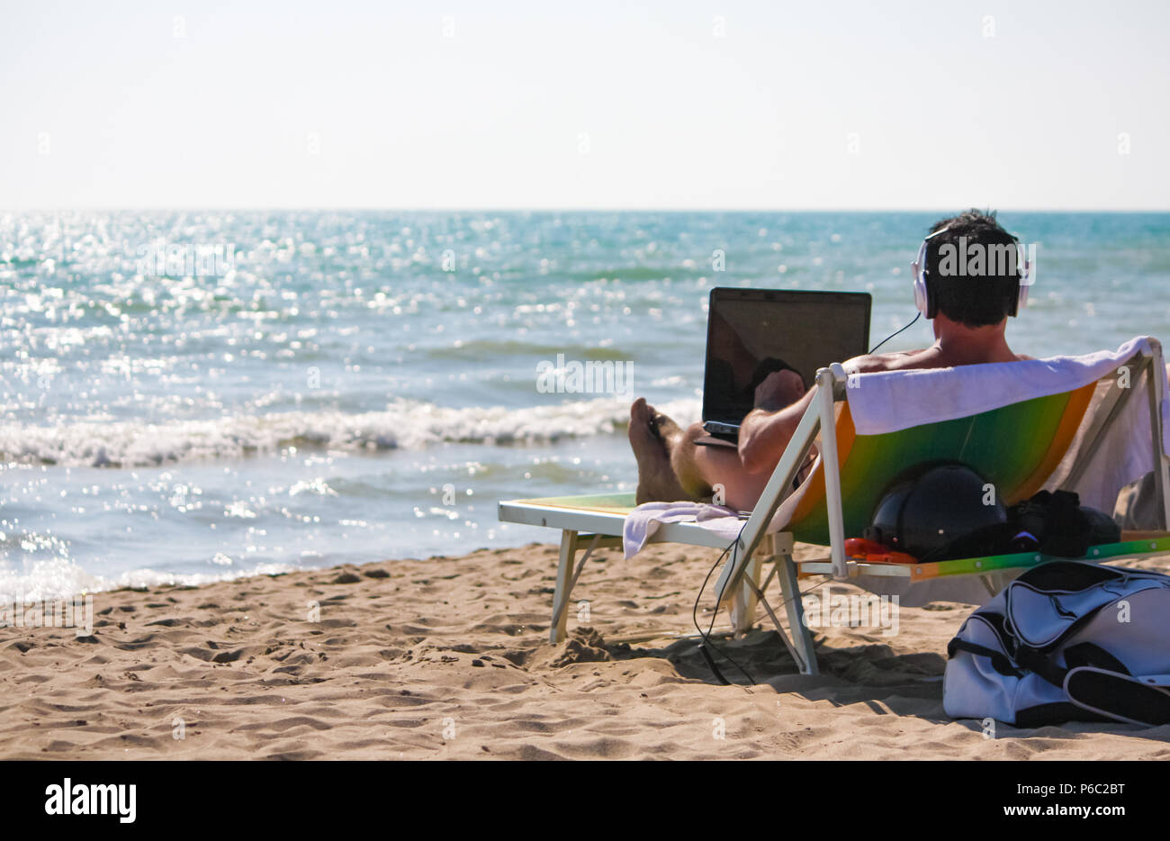 Businessman sitting deck chair laptop hi-res stock photography and ...