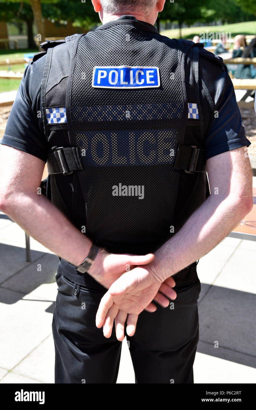 Uniformed police officer on duty at a local school, Alton, Hampshire ...