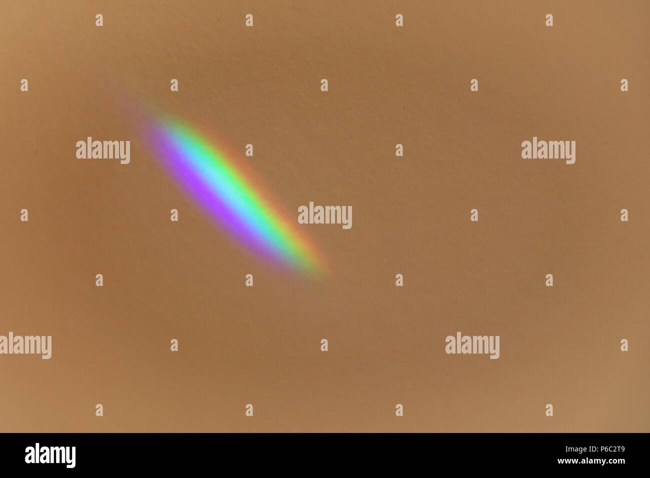 Light dots on plaster. Photo of rainbow labs on beige wall Stock Photo ...