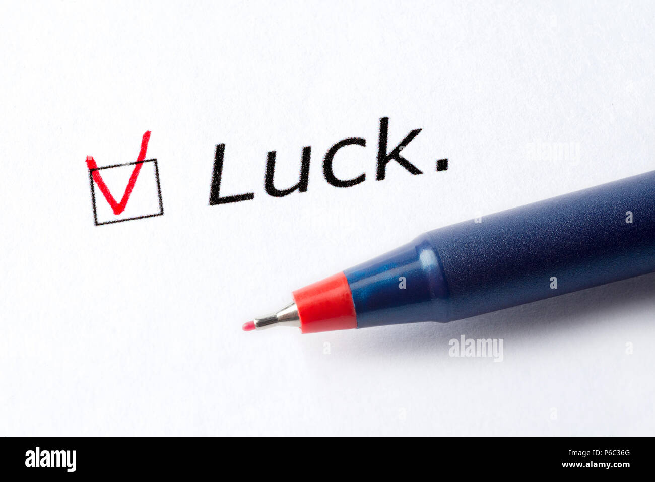 The word luck is printed on a white background. Check mark in red ...
