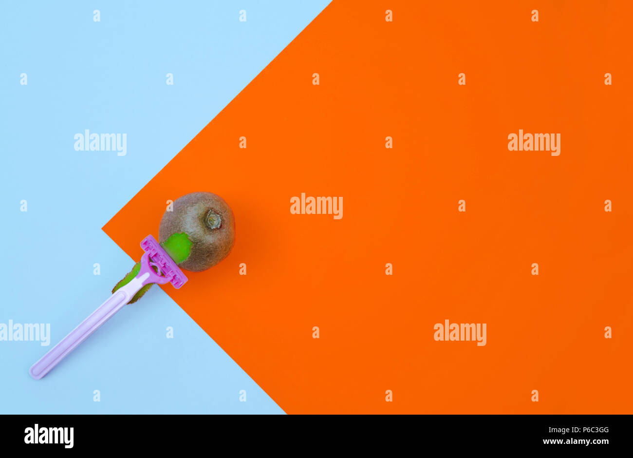 Kiwi fruit and razor on blue and orange background. Hair removal ...