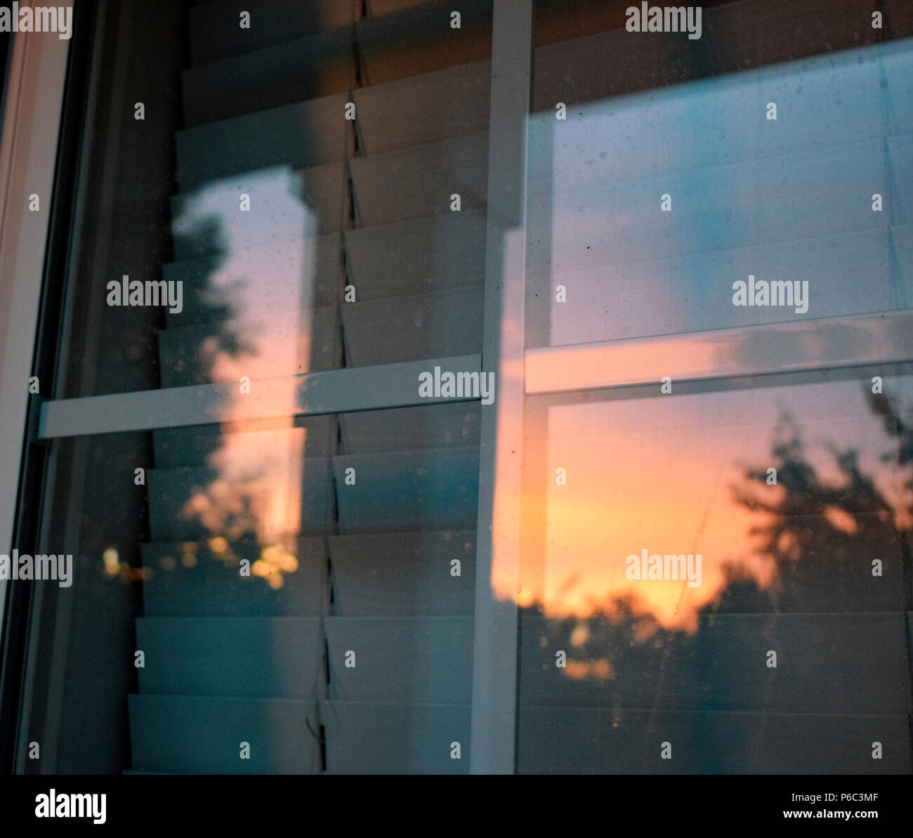 Setting Sun reflected on a Window Stock Photo - Alamy