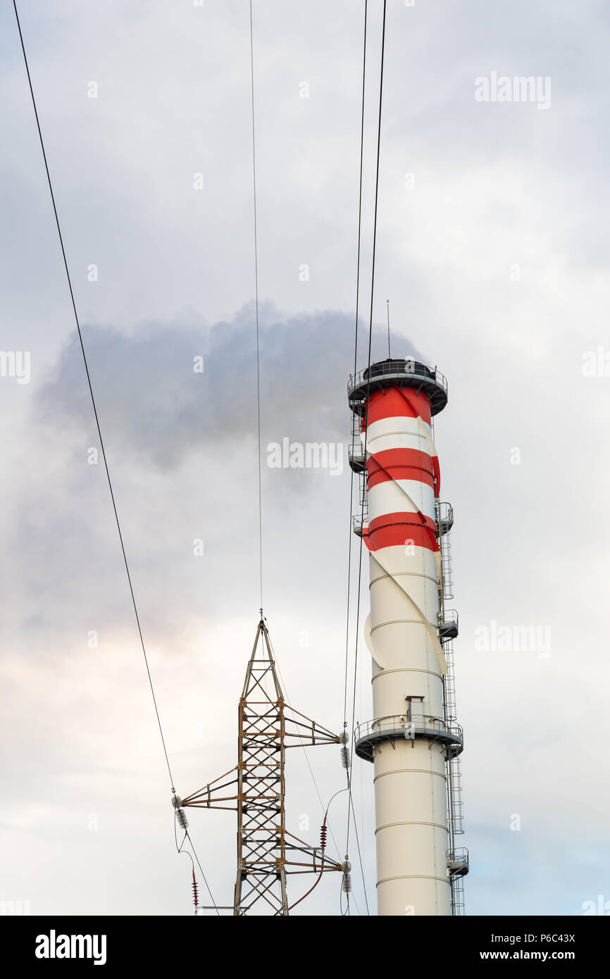 view of an industrial chimney with a turret electricity Stock Photo - Alamy