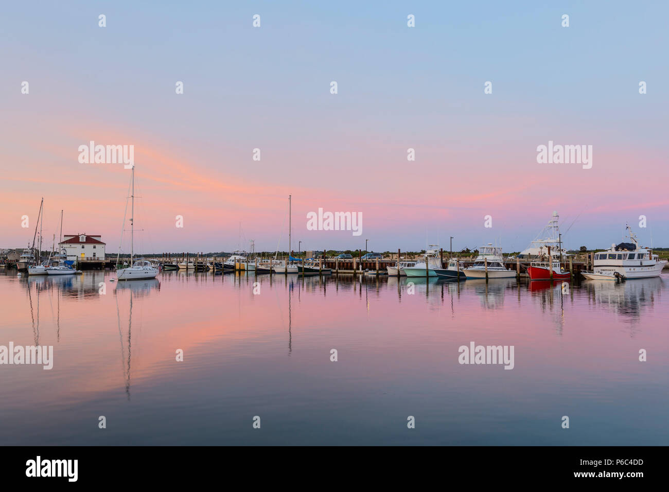 Commercial fishing boats docked in Menemsha Basin under a pre-sunrise ...