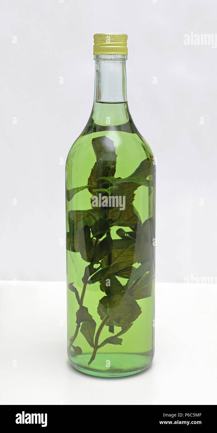 Fruit brandy with medical herbs in bottle Stock Photo - Alamy