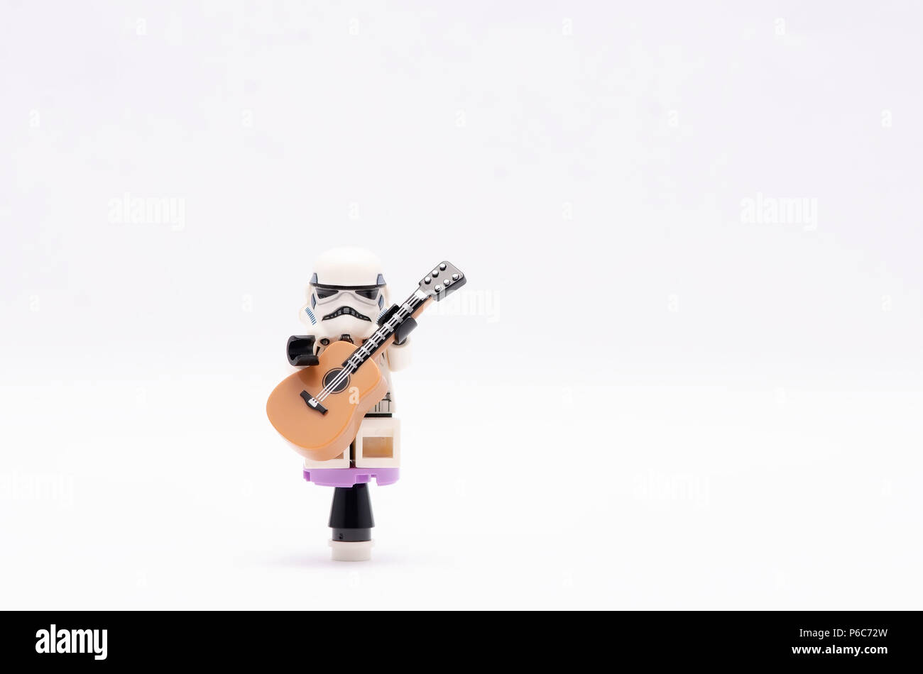mini figure of storm trooper sitting on chair playing guitar. Lego ...