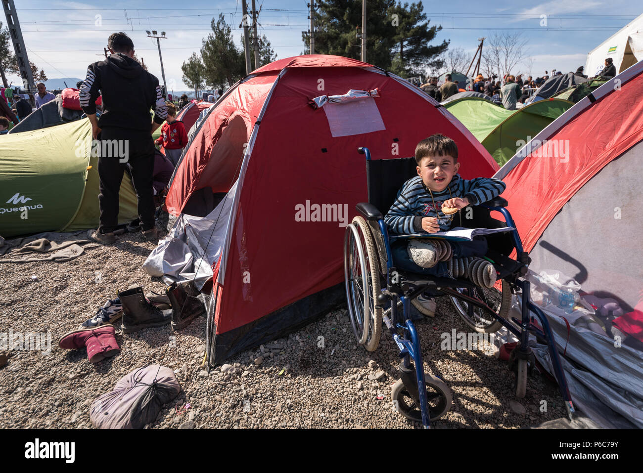 A refugee boy on a wheelchair of the makeshift camp of the Greek ...