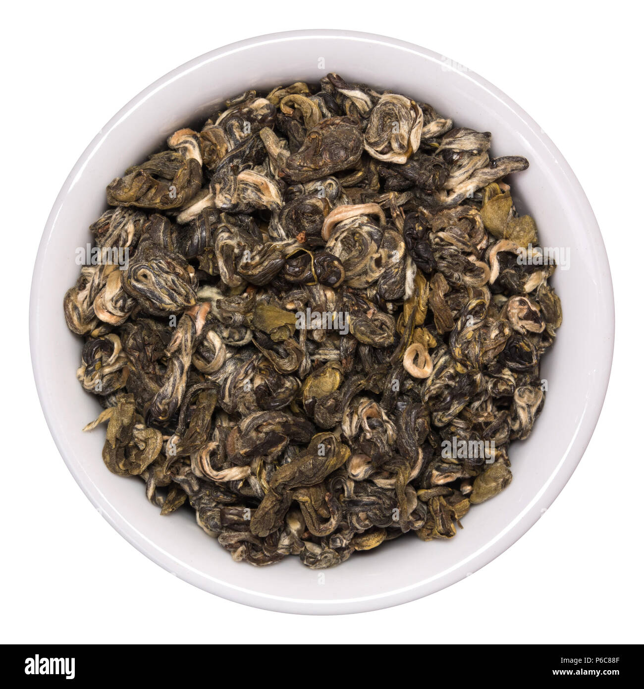 Pile of dry green tea Bilochun snail in white bowl isolated on white ...