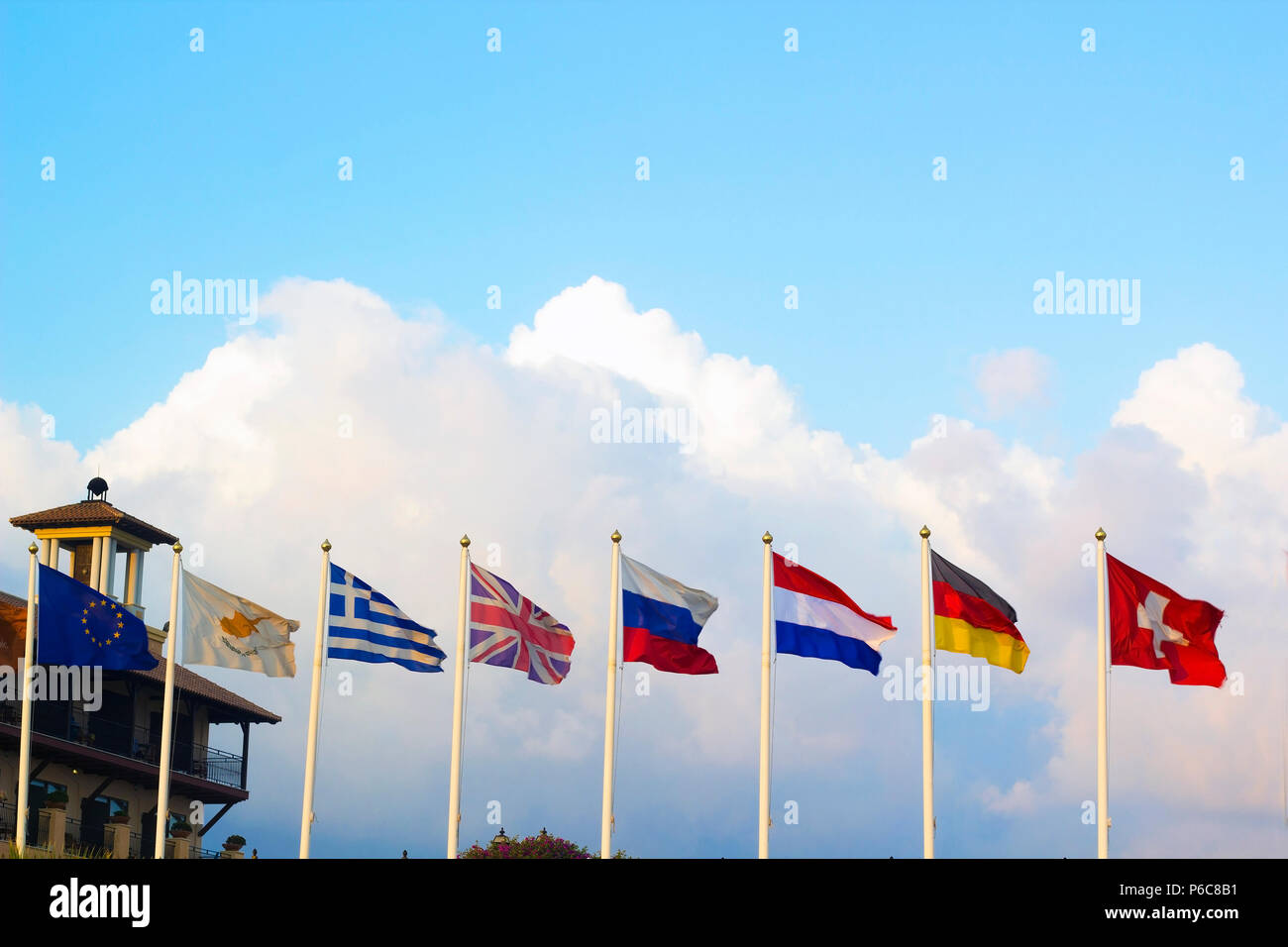 Flags of different countries flapping in wind against blue sky Stock ...