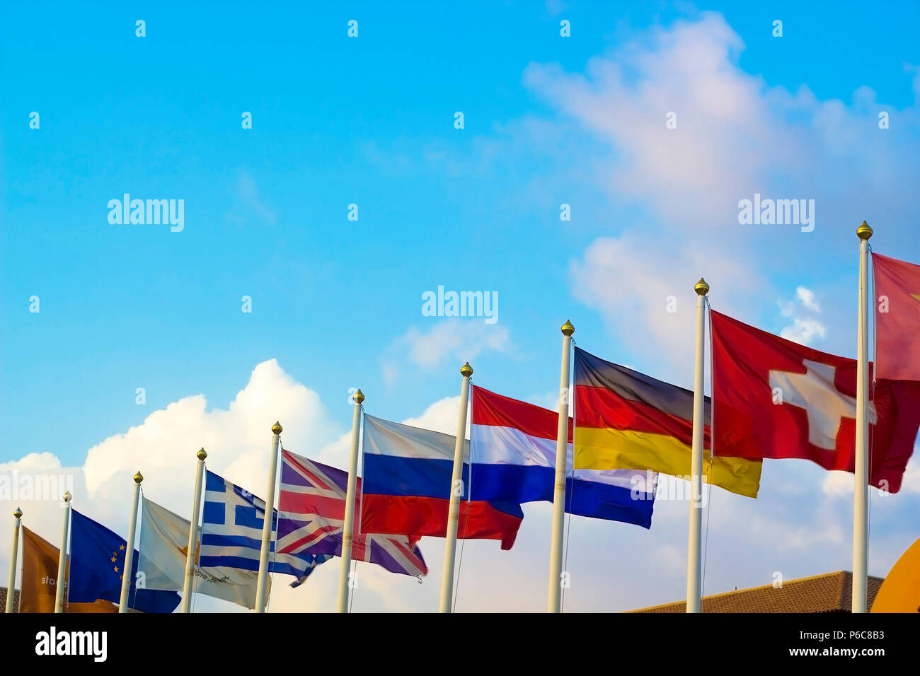 Flags of different countries flapping in wind against blue sky Stock ...