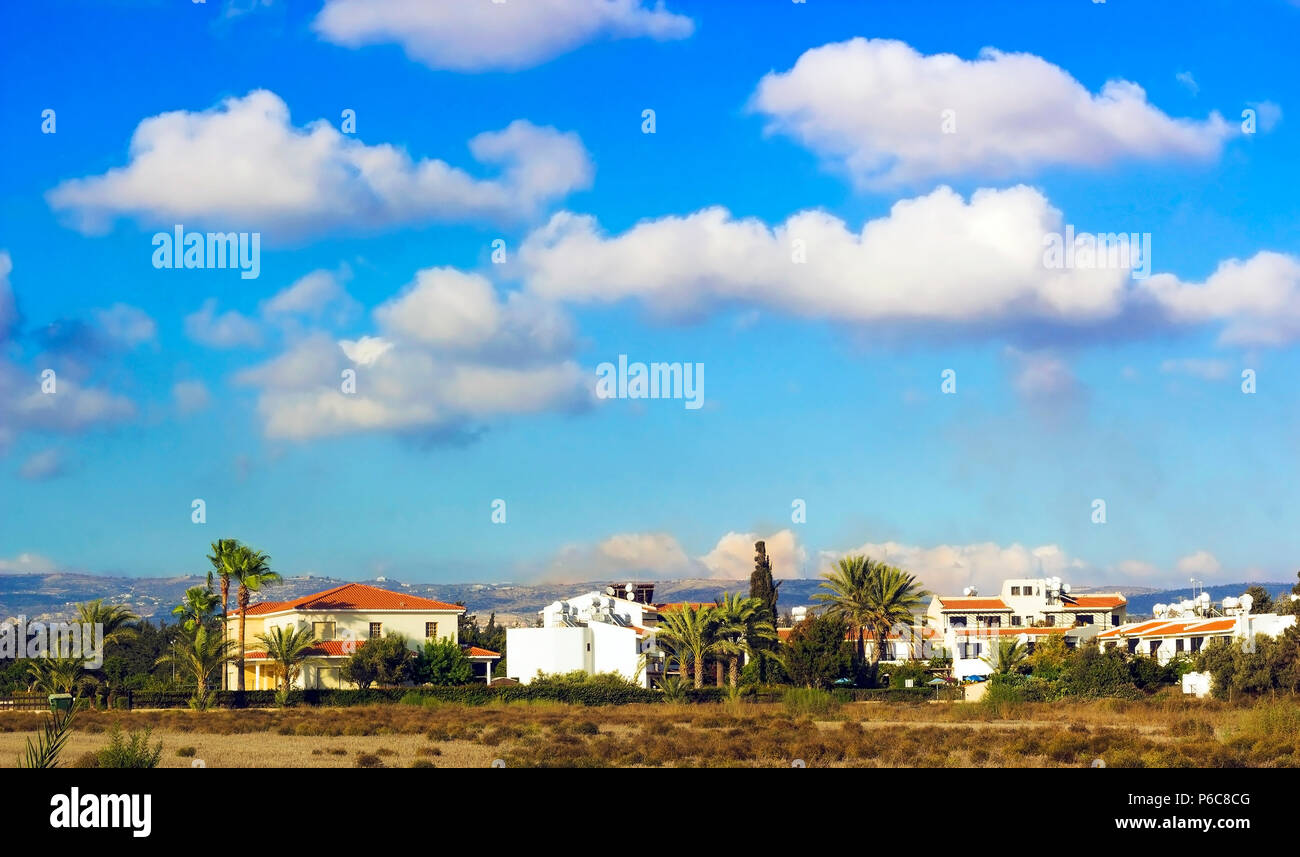 Landscape of town Paphos with houses, trees and mountains in background ...