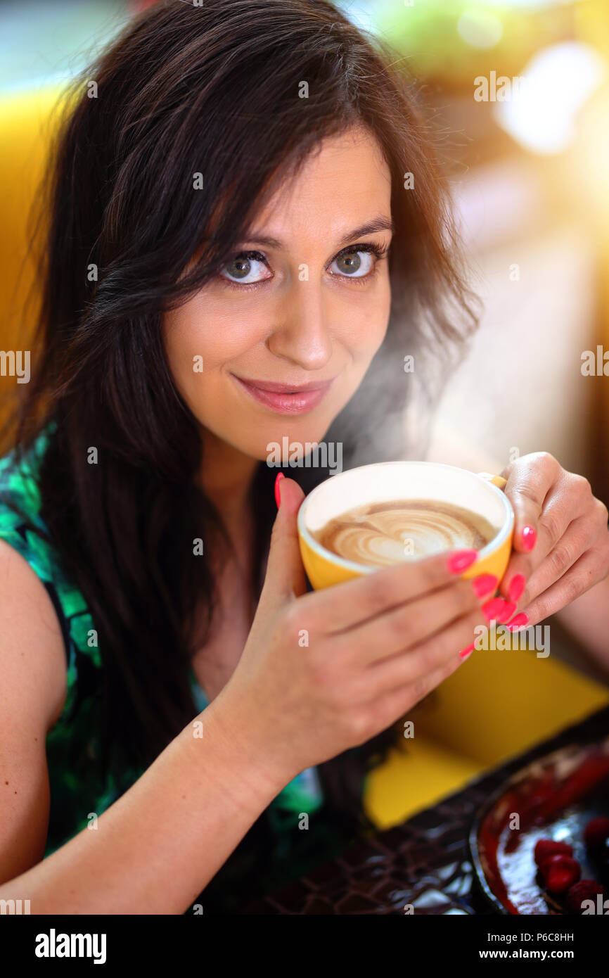smiling girl drinking her favorite coffee Stock Photo - Alamy