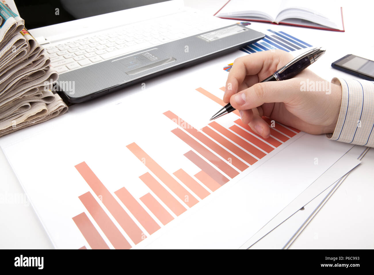 hand holding a pen at work near the notebook close-up Stock Photo - Alamy