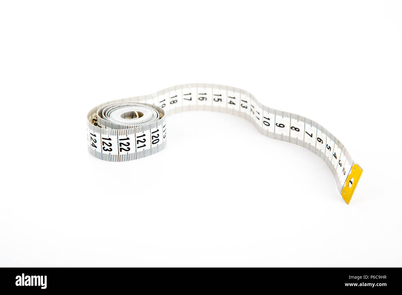 rolled centimeter ruler on a white background Stock Photo - Alamy