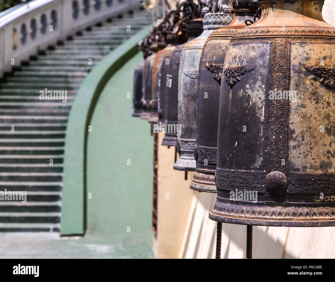 Old traditional prayer bells hanging at the entrance stairway to a ...