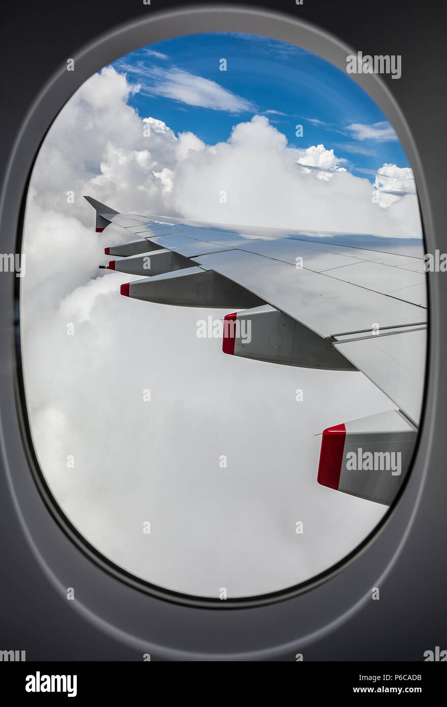 View of an airplane wing out the window from the seat inside a ...