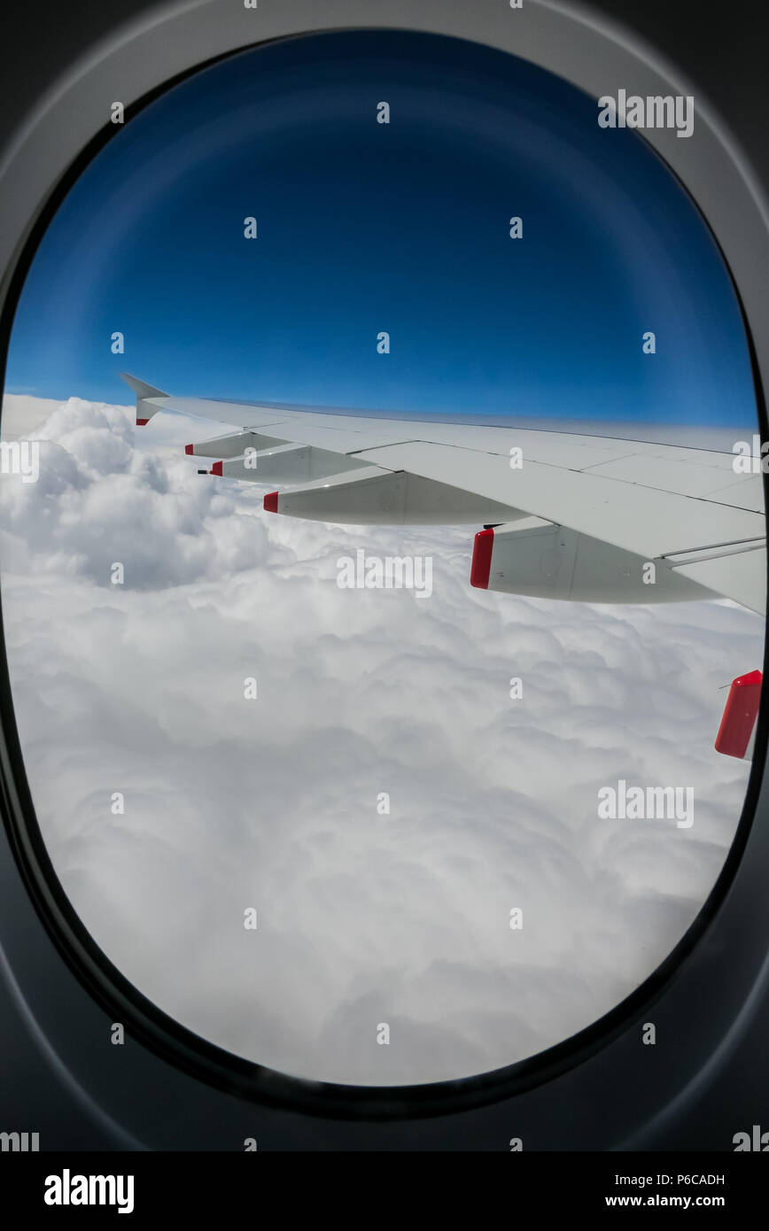 View of an airplane wing out the window from the seat inside a ...