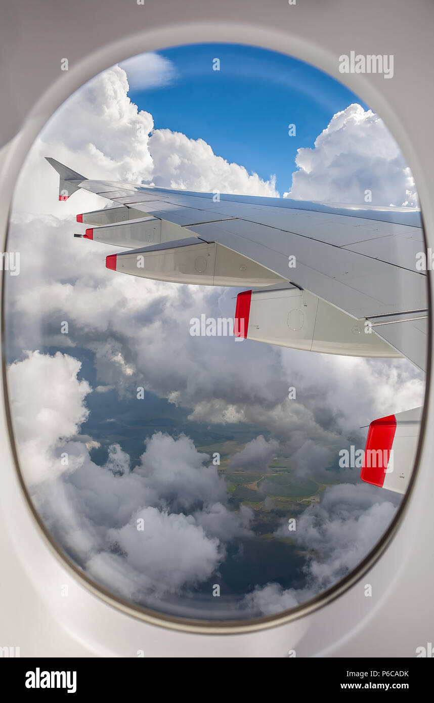 View of an airplane wing out the window from the seat inside a ...