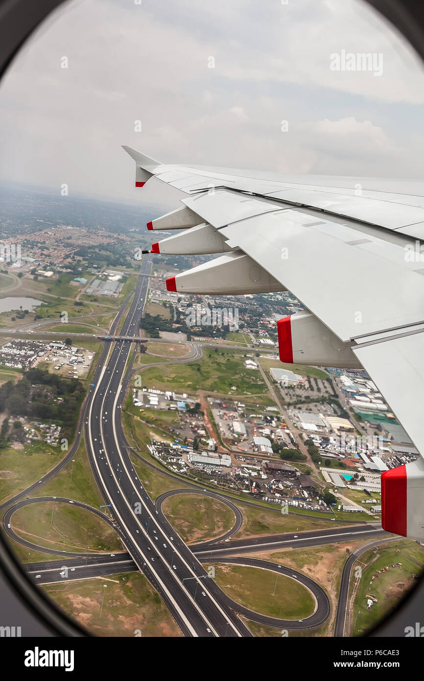 View of an airplane wing out the window from the seat inside a ...