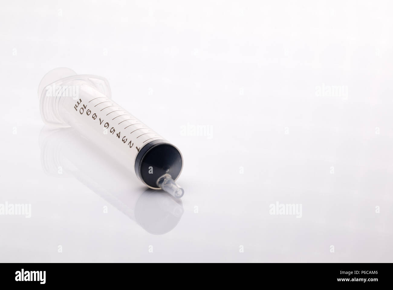 Clear plastic syringe isolated on a white background. Scientific ...