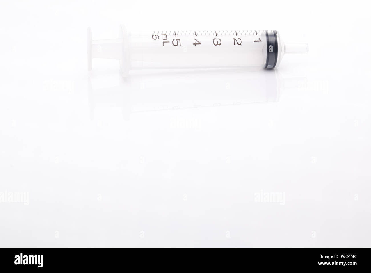 Clear plastic syringe isolated on a white background. Scientific ...