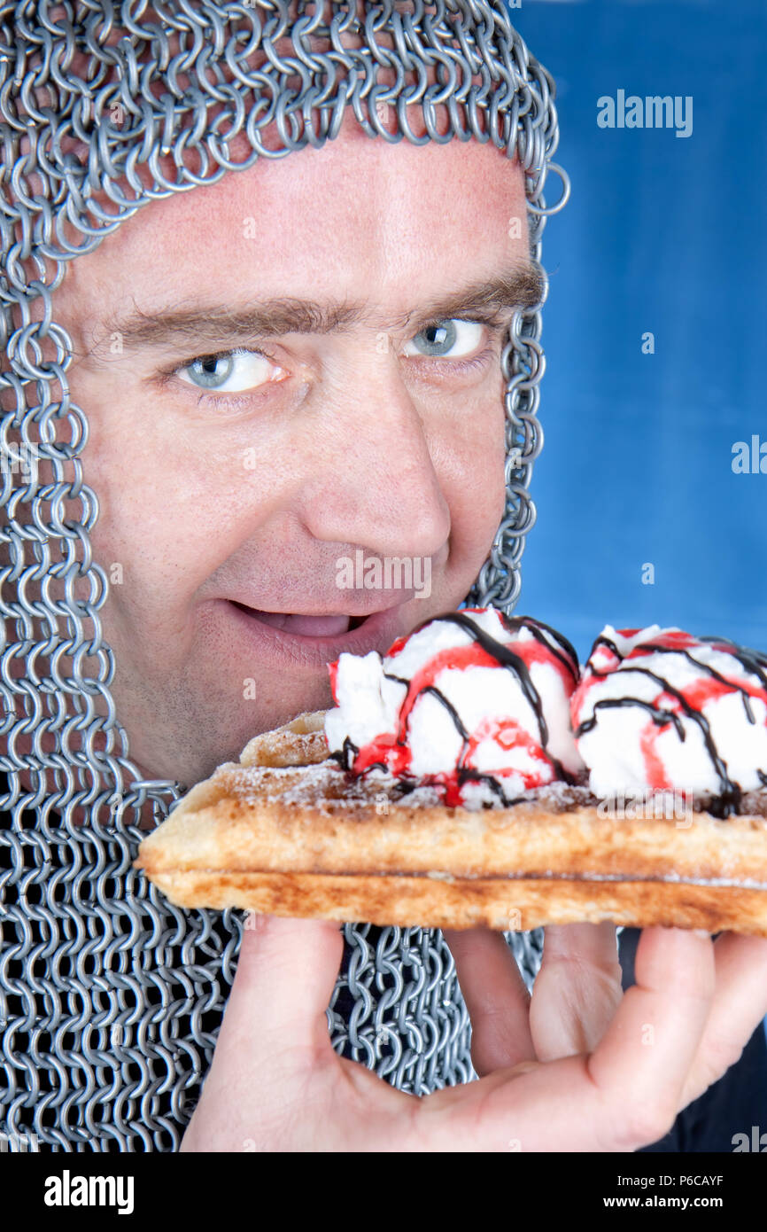 Knight eating waffle with ice-cream , studio shot Stock Photo - Alamy