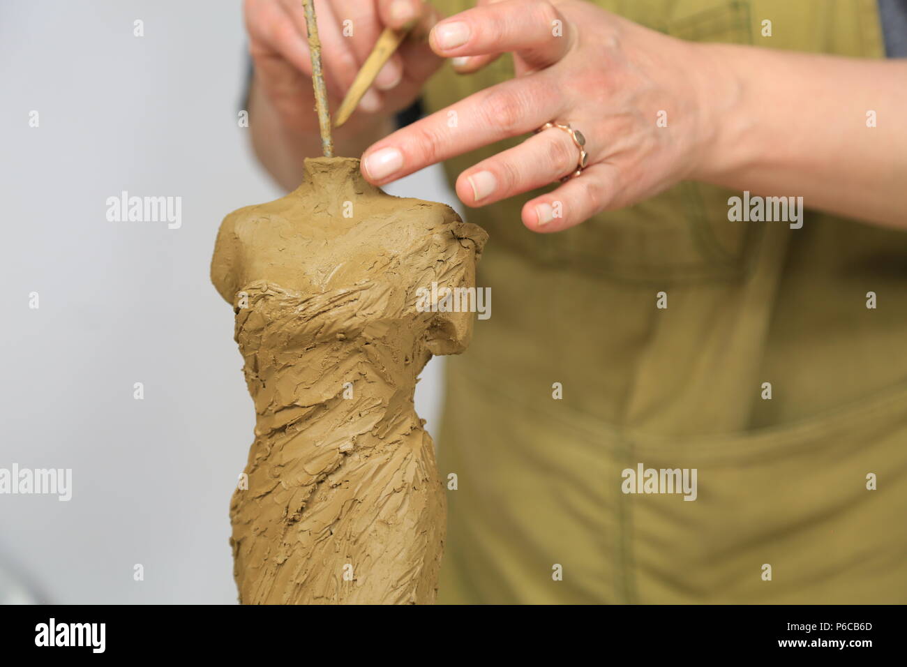 Sculptor artist creating a bust sculpture with clay Stock Photo - Alamy