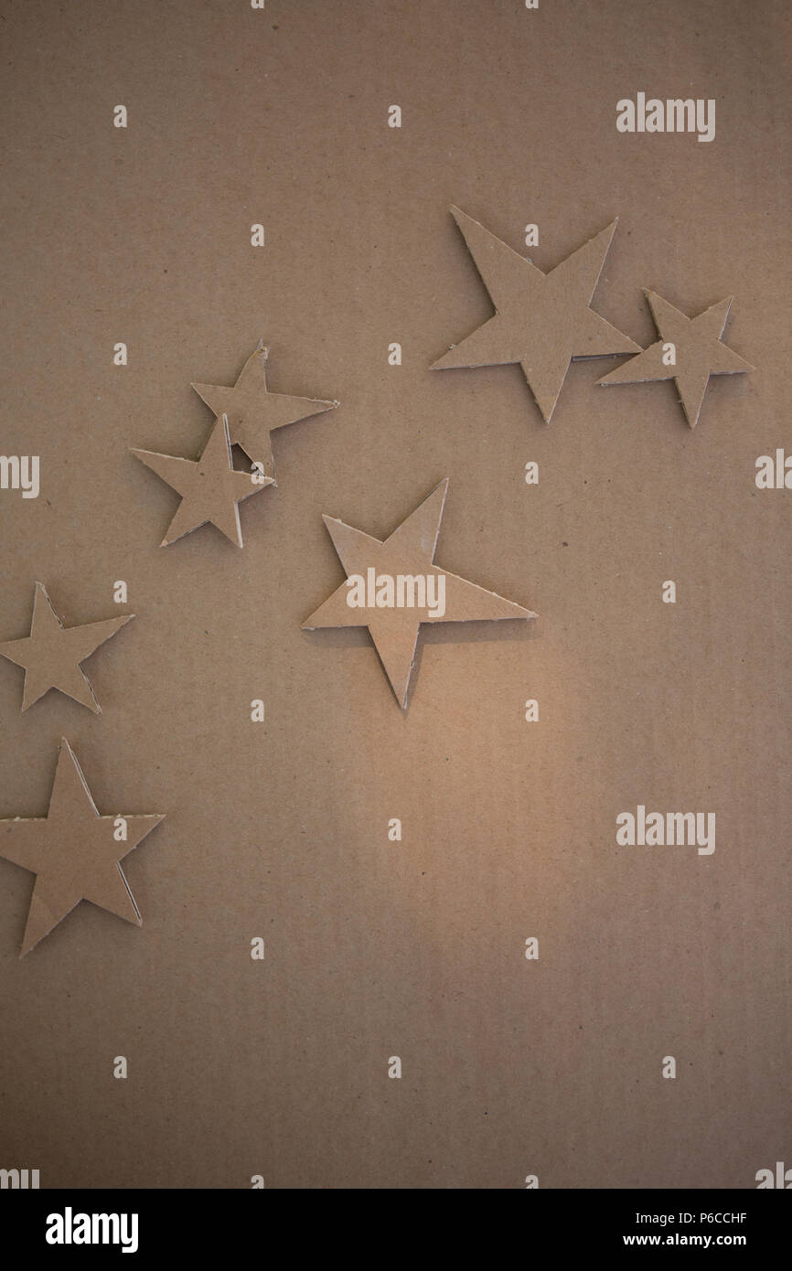 Cardboard stars on a brown background. Eco-style Stock Photo - Alamy