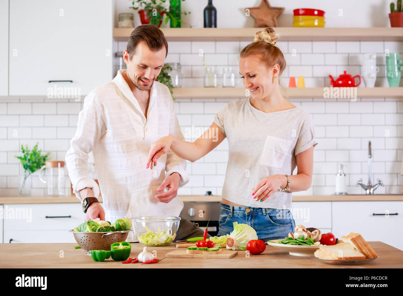 Picture of man and woman cooking vegetables in kitchen Stock Photo - Alamy